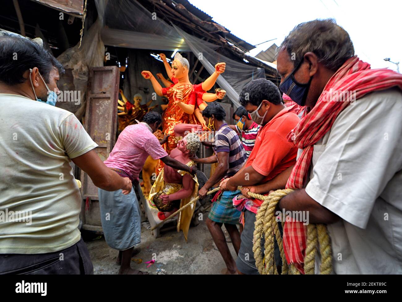 Porters seen carrying the Idol of Hindu God Devi Durga from the artist ...