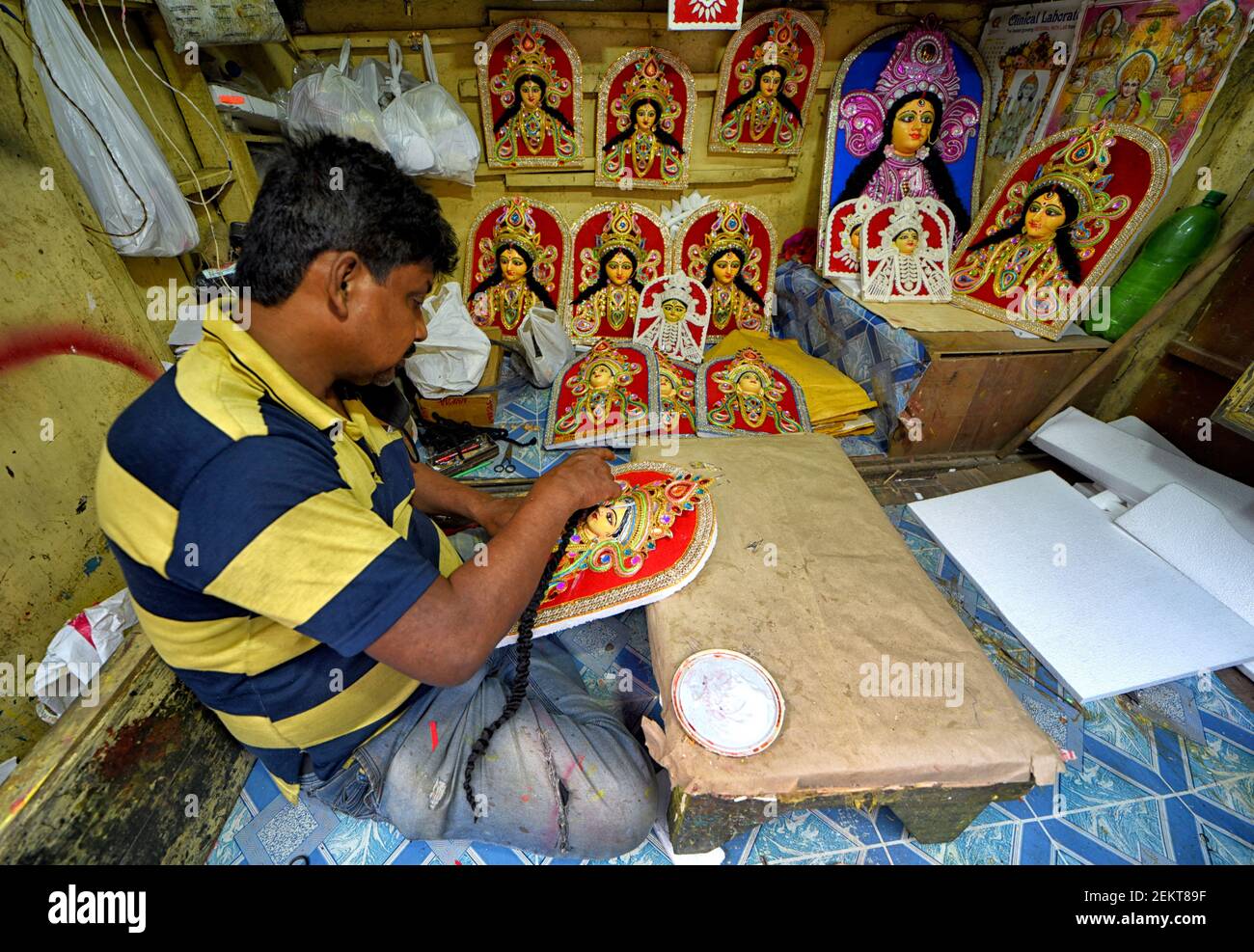 An artist seen giving a final touch on an idol of Hindu God Devi Durga ...