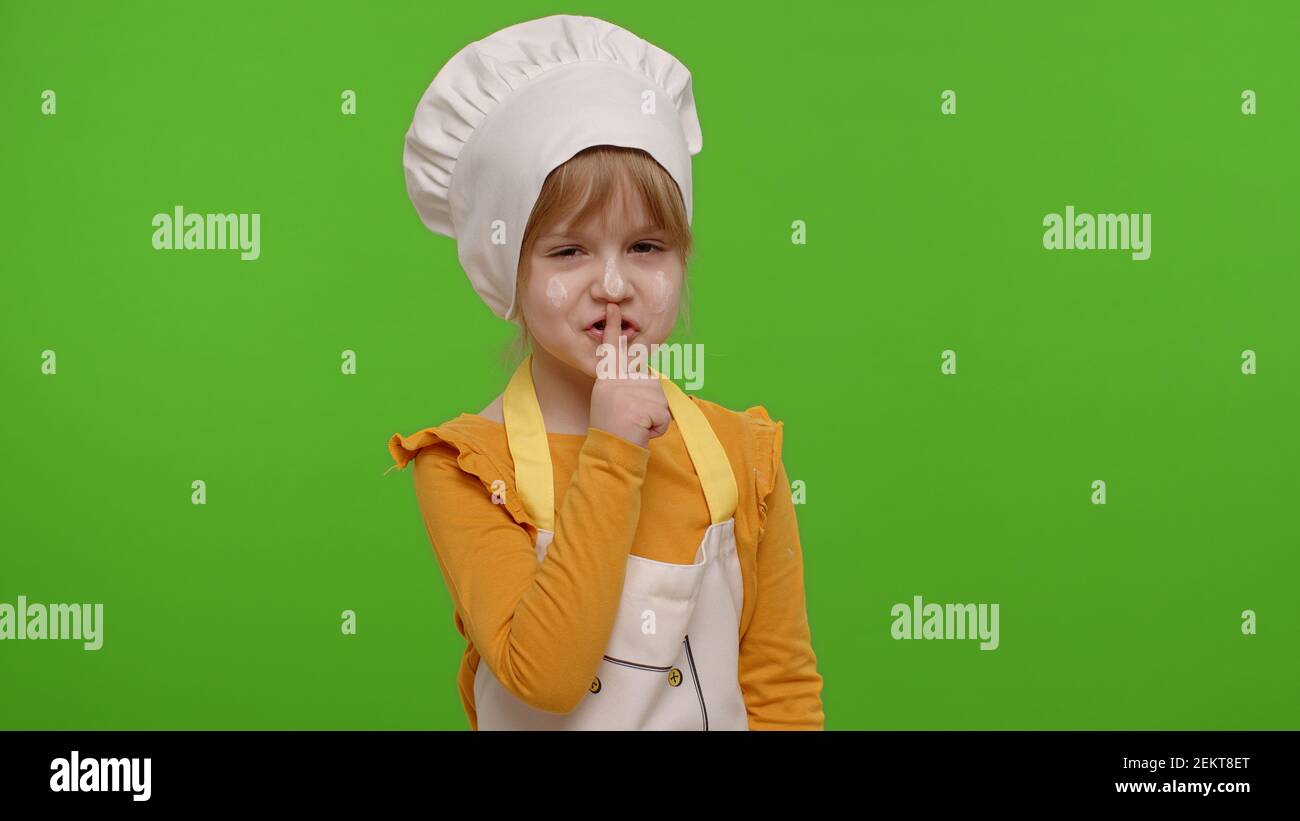 Child girl kid dressed as professional cook chef holding finger on her ...