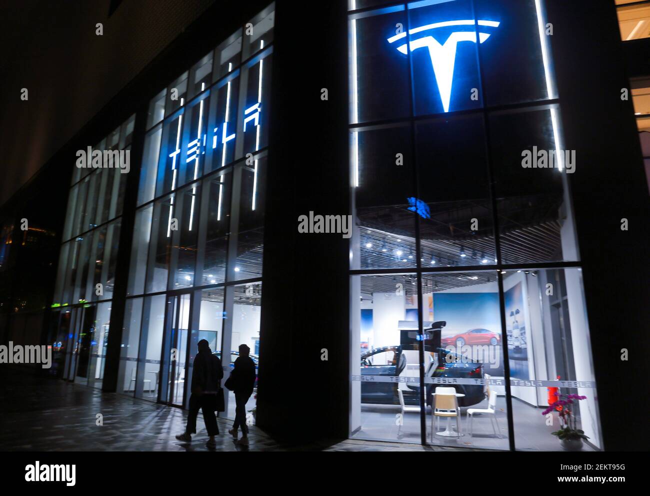 SHANGHAI, CHINA - OCTOBER 16, 2020 - Pedestrians walk past the Tesla ...