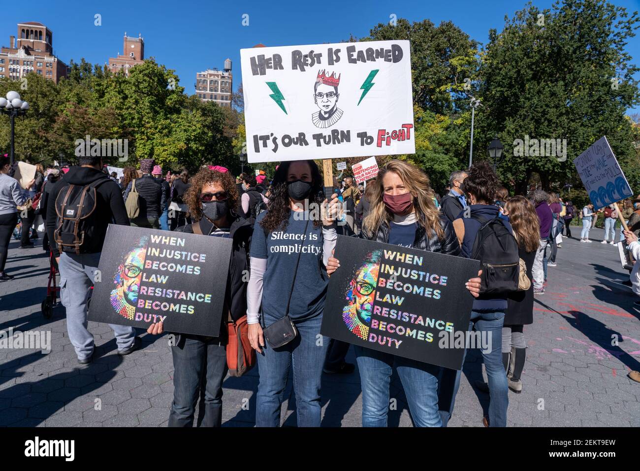 Protesters hold placards expressing their opinions at Washington Square ...