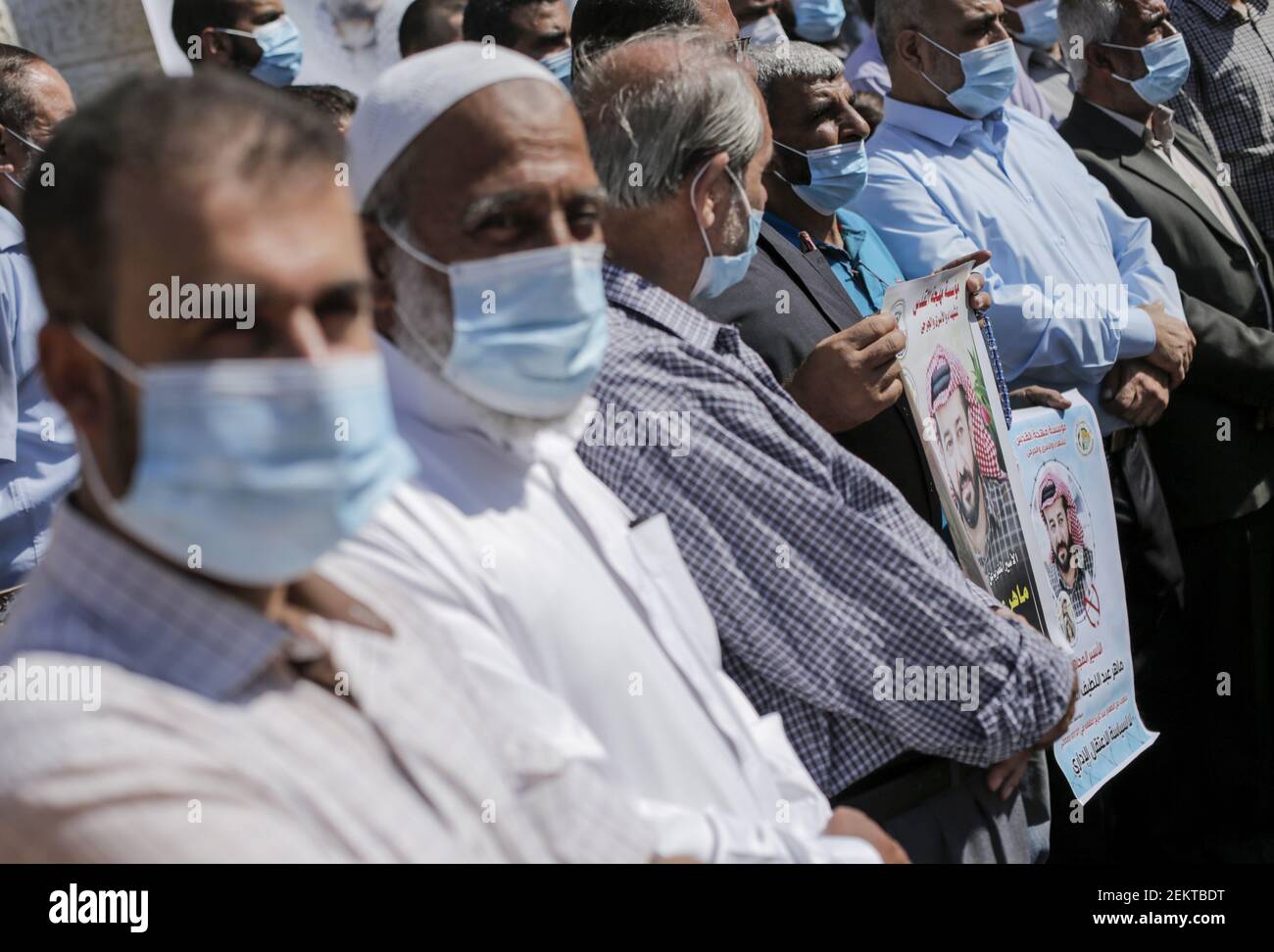 A protester holding a placard with the image of Maher Al-Akhras, during ...