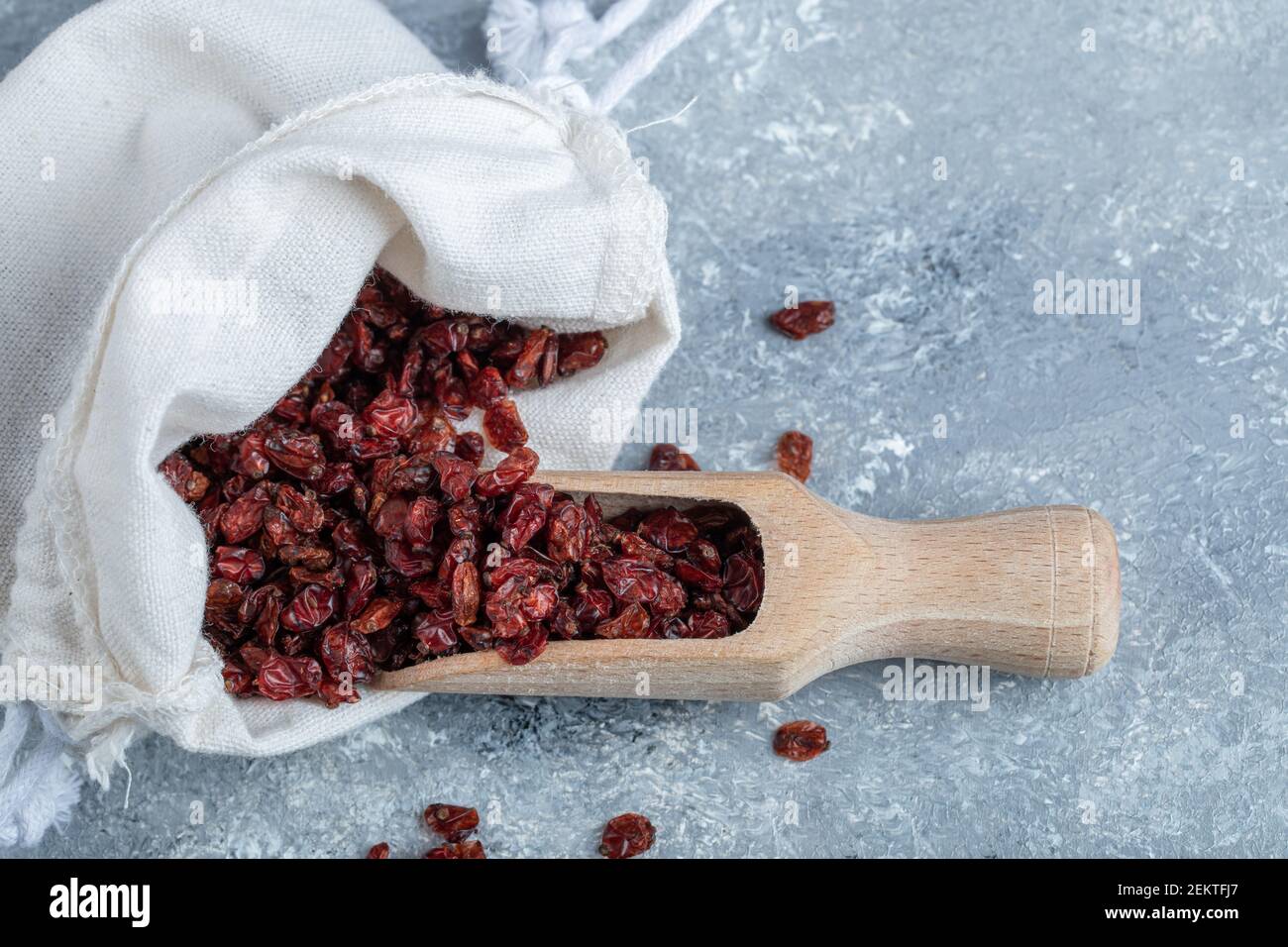 A wooden spoon full of dried cranberries on marble surface Stock Photo ...