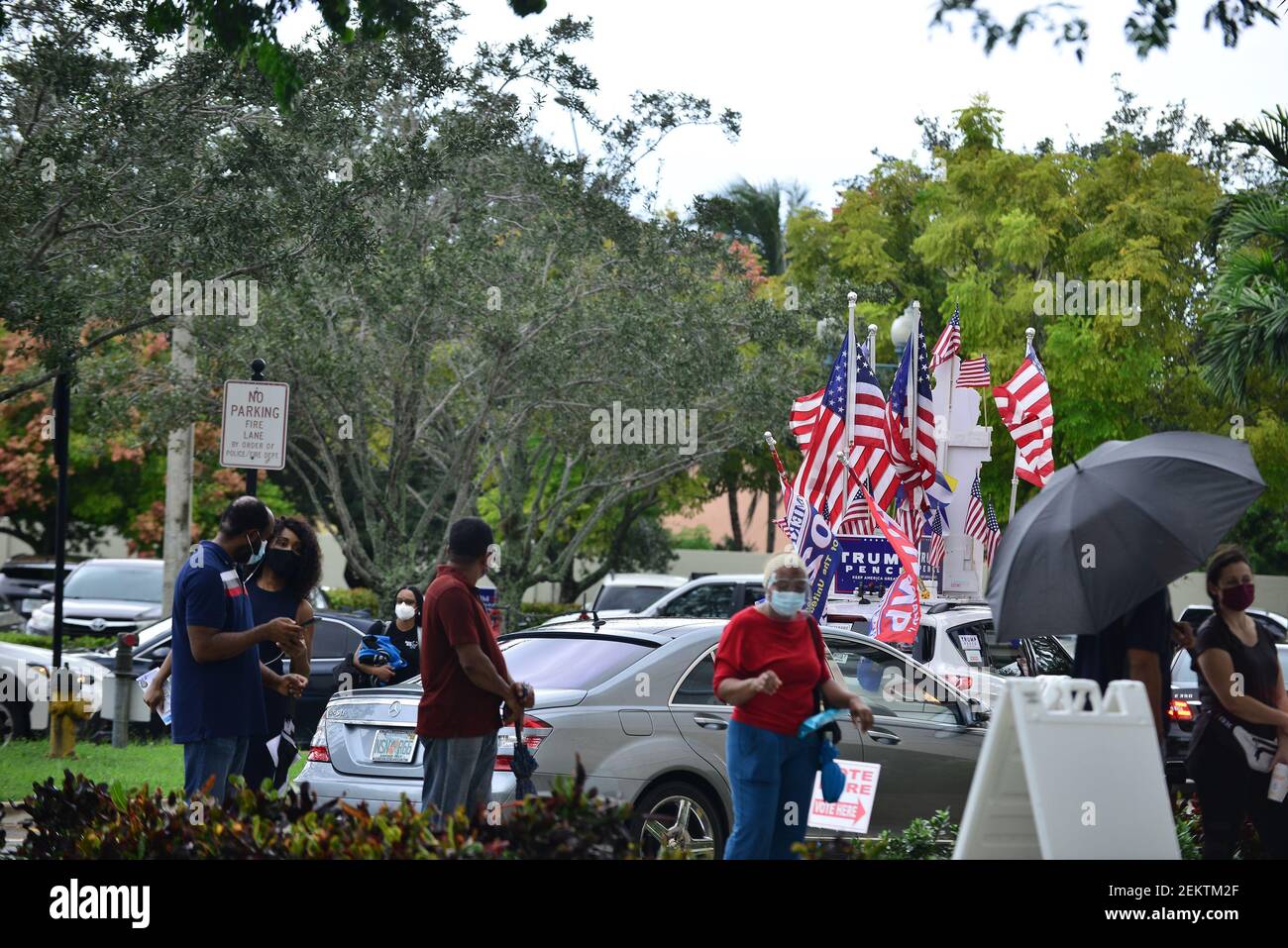 Voters wait in line, in the rain, to cast their early ballots at the ...