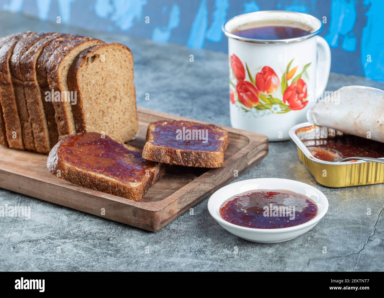 Strawberry jam with slice of brown bread and cup of tea Stock Photo - Alamy