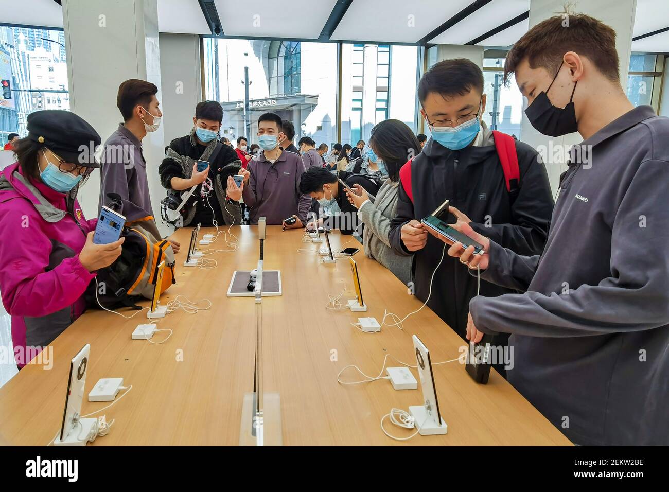 Customers queue at the flagship store of Huawei located on the east ...