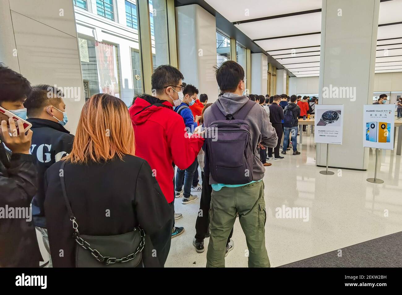 Customers queue at the flagship store of Huawei located on the east ...