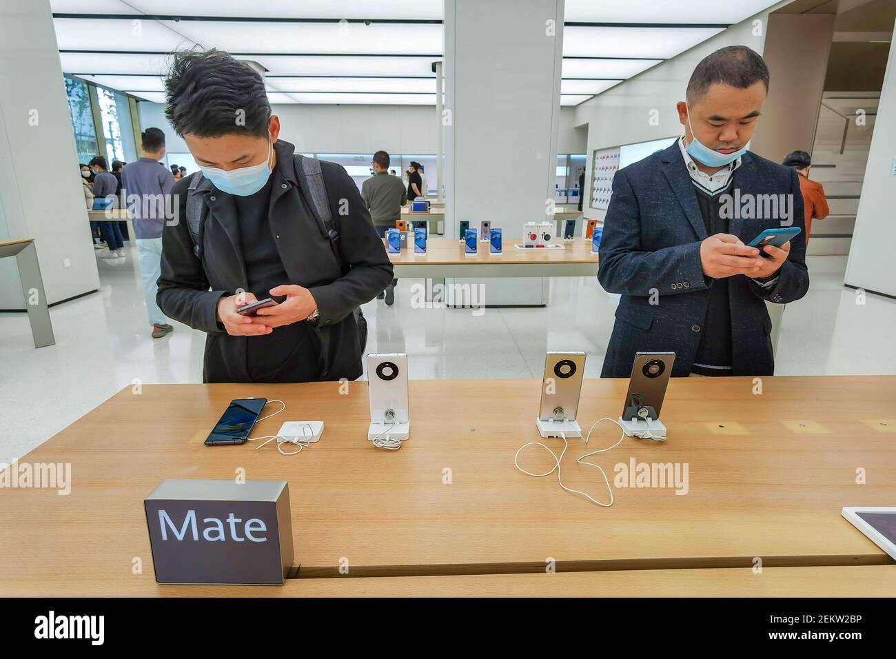 Customers queue at the flagship store of Huawei located on the east ...