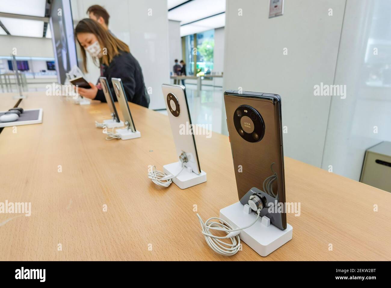 Customers queue at the flagship store of Huawei located on the east ...