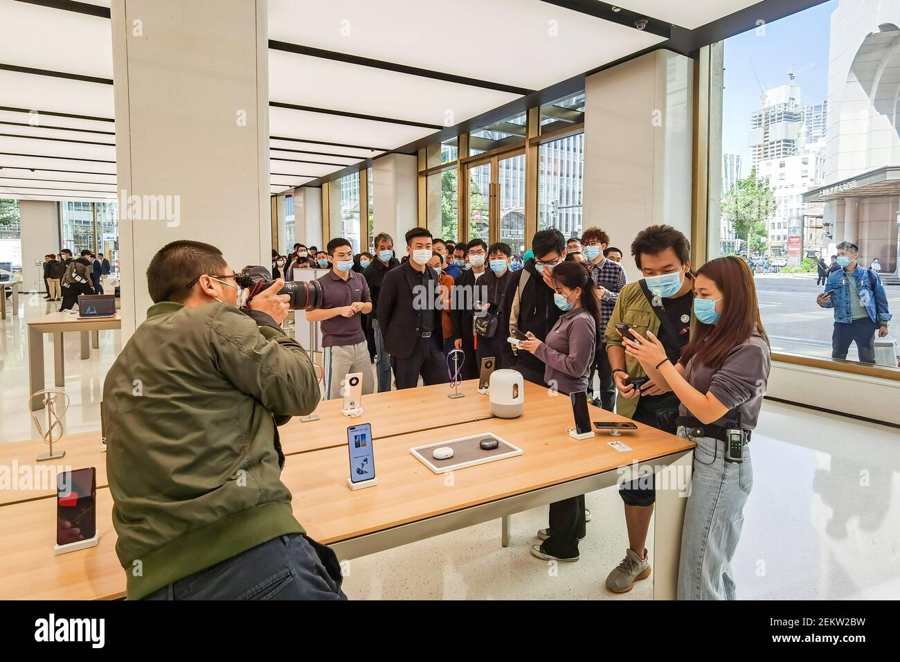 Customers queue at the flagship store of Huawei located on the east ...