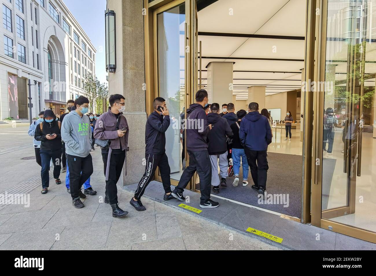 Customers queue at the flagship store of Huawei located on the east ...