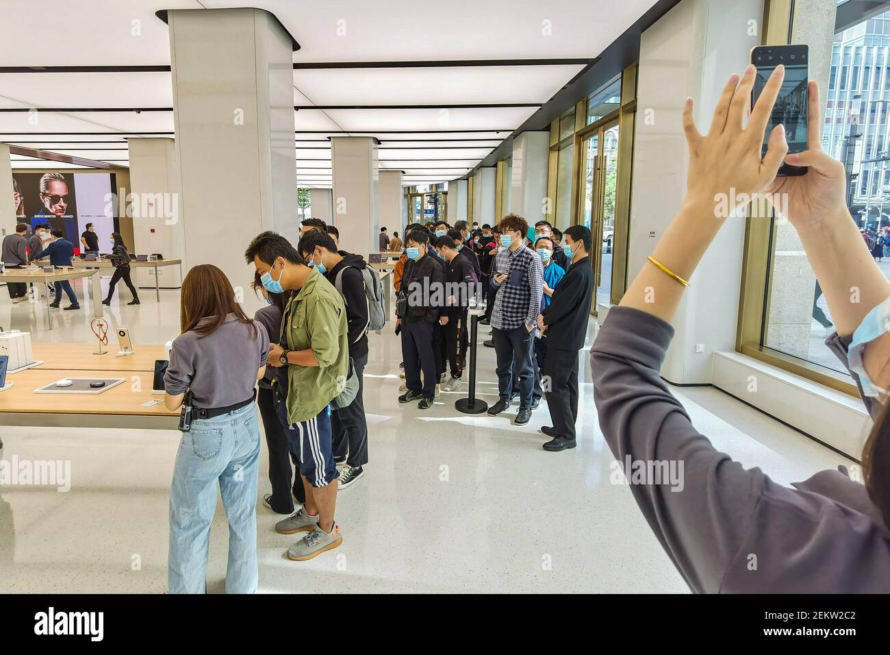 Customers queue at the flagship store of Huawei located on the east ...