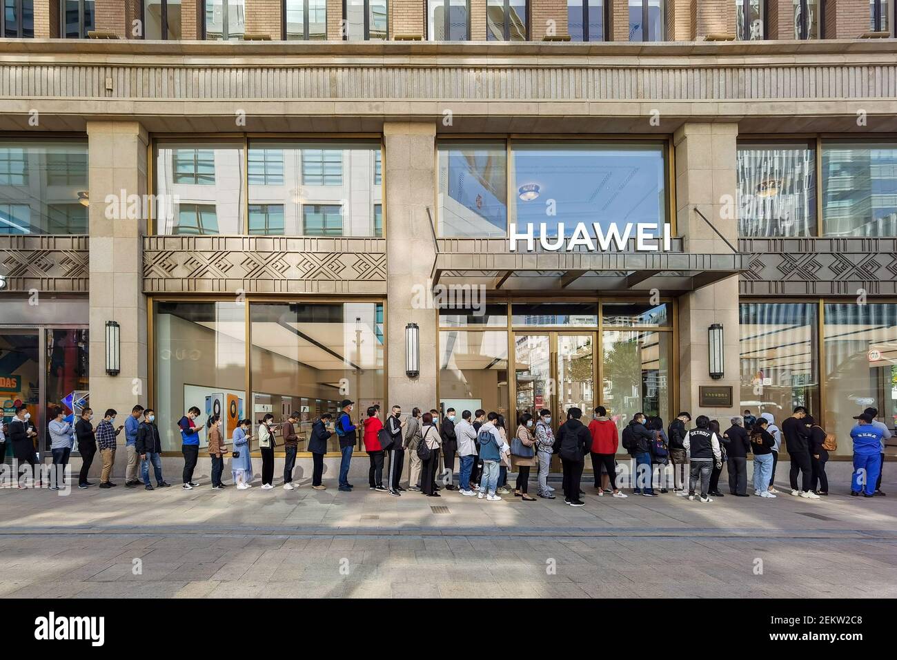 Customers queue at the flagship store of Huawei located on the east ...