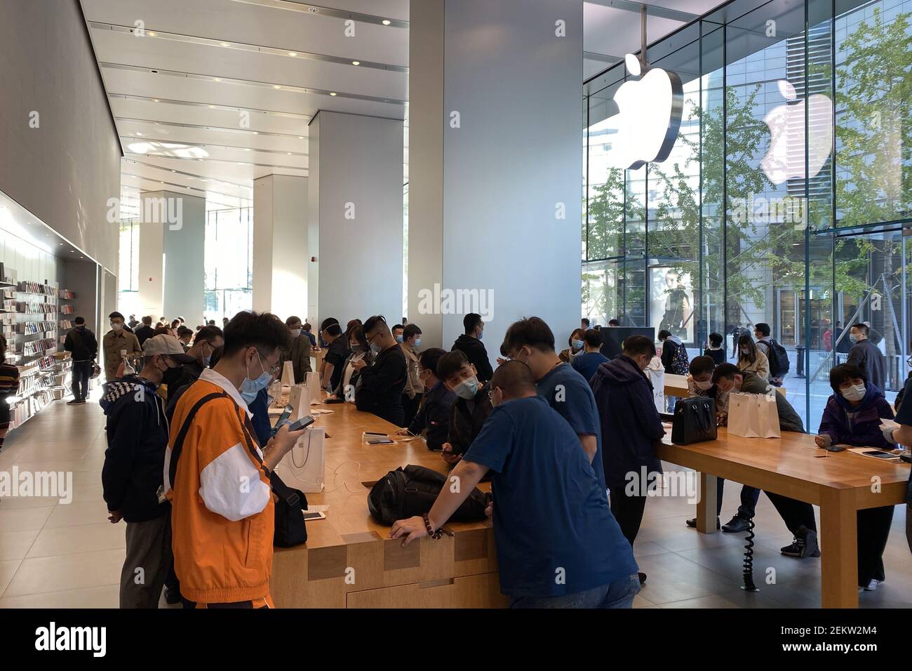 Customers queue to experience and purchase the newly released iPhone 12 ...