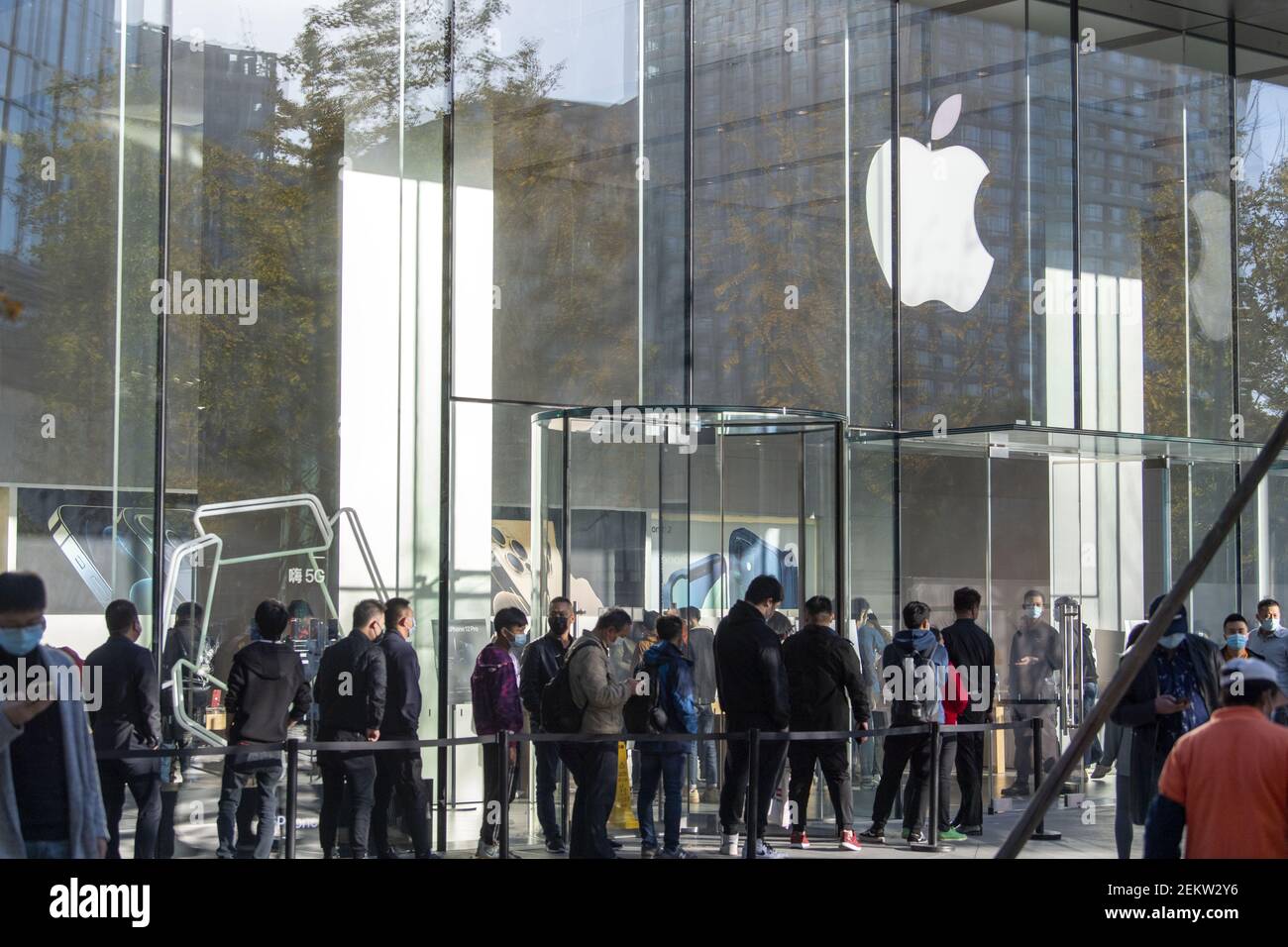 Customers queue to experience and purchase the newly released iPhone 12 ...