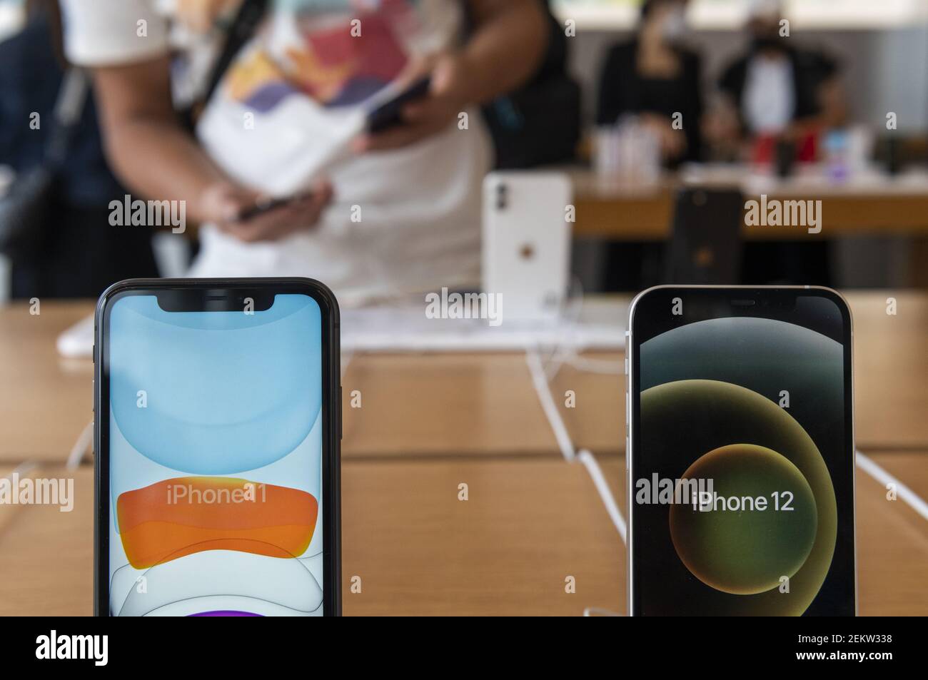 The new iphone 12 smartphone next to the Iphone 11 as a customer tests ...