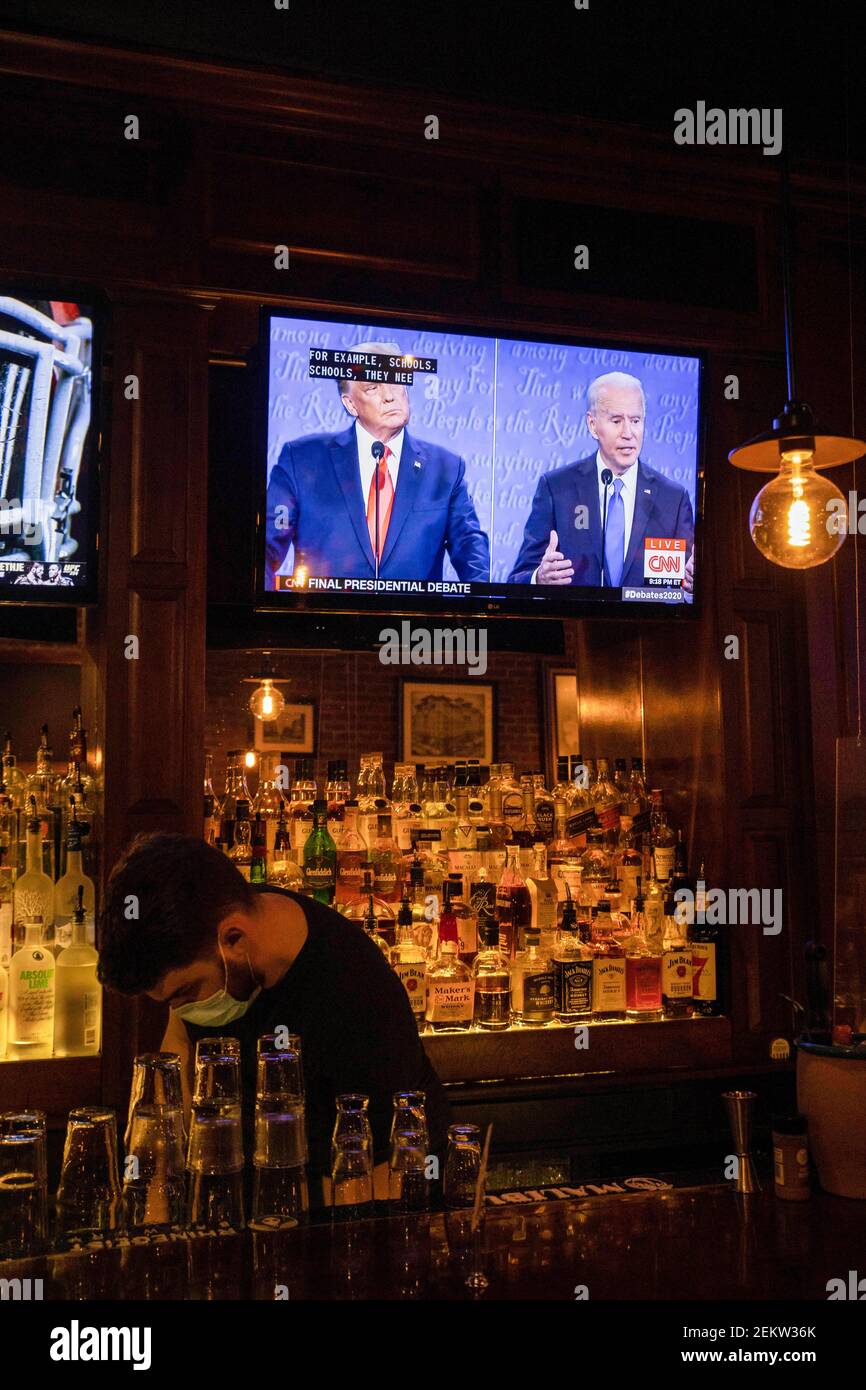 Donald Trump and Joe Biden seen speaking on a Tv screen at Oddfellows ...