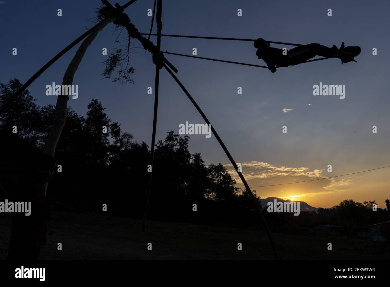 A boy plays on a traditional swing locally known as ping during the ...