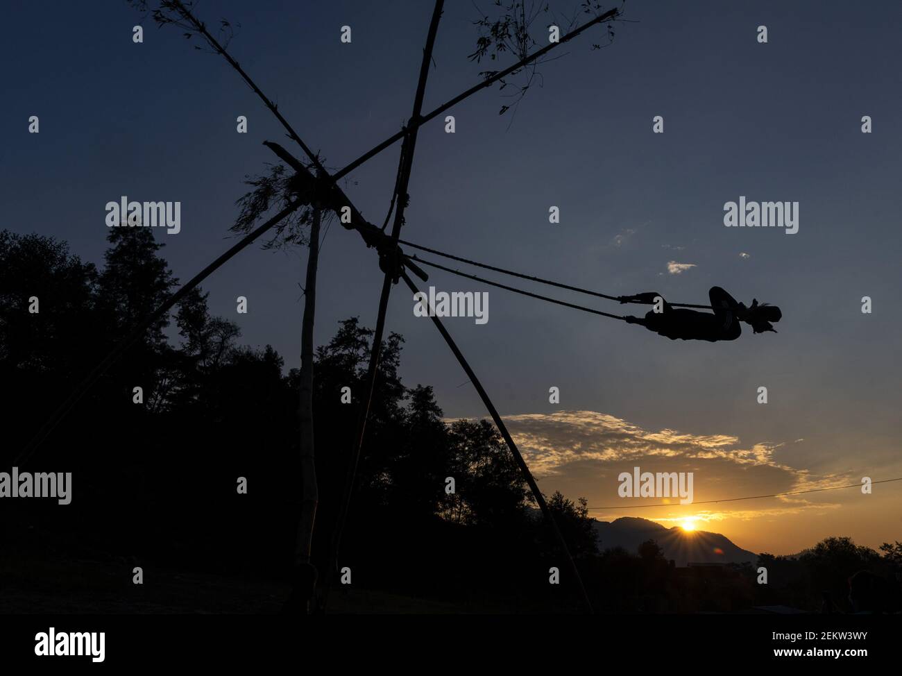 A boy plays on a traditional swing locally known as ping during the ...