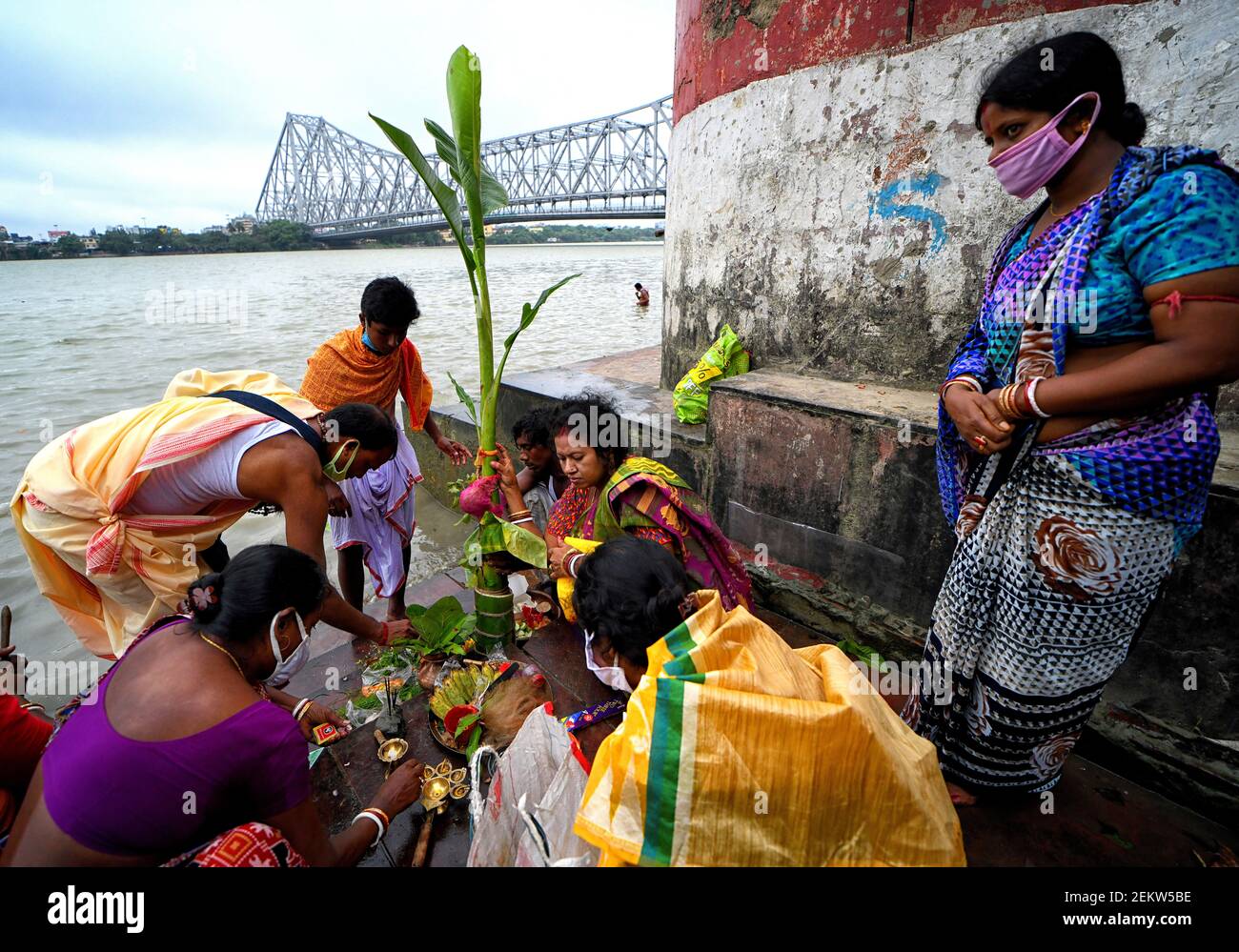 Hindu people are seen with a banana plant to mark Nabapatrika, the ...