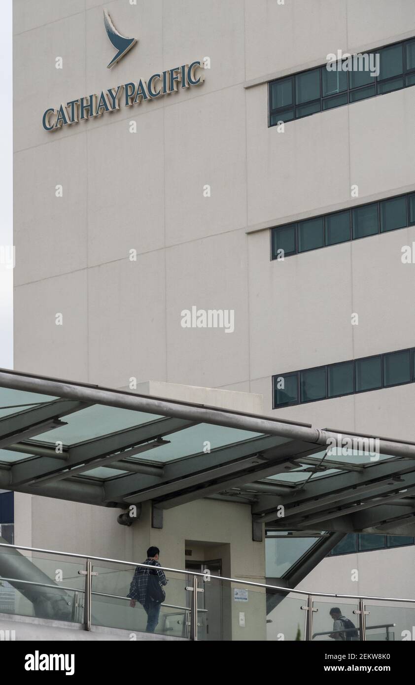 People walking through a pedestrian bridge at the Cathay Pacific City ...