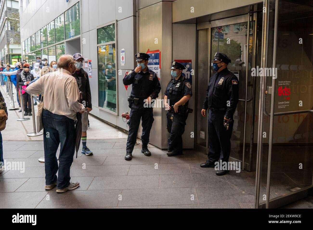 NYPD Police Officers and security stand at the entrance to the voting ...