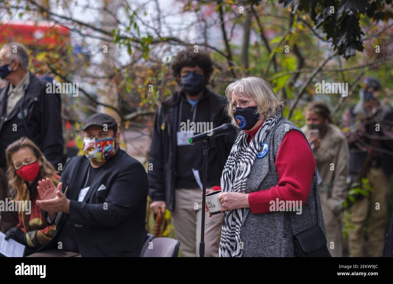 Bloomington city council woman Susan Sandberg speaks wearing a face ...
