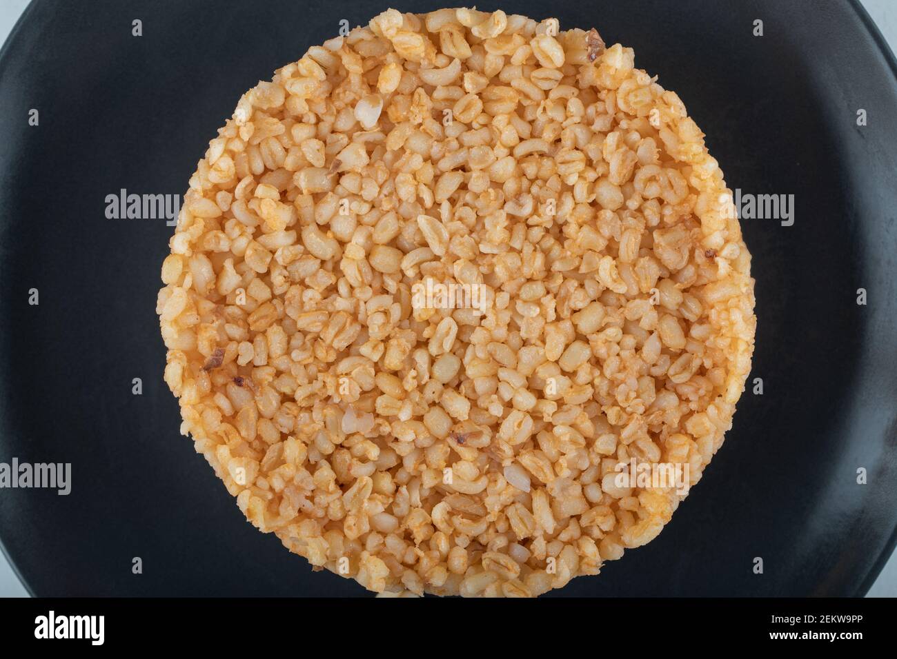 Turkish food bulgur rice on dark plate on a white background Stock ...