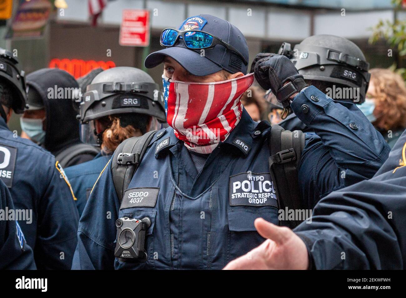 An NYPD officer wears an American flag face mask at a Trump rally in ...