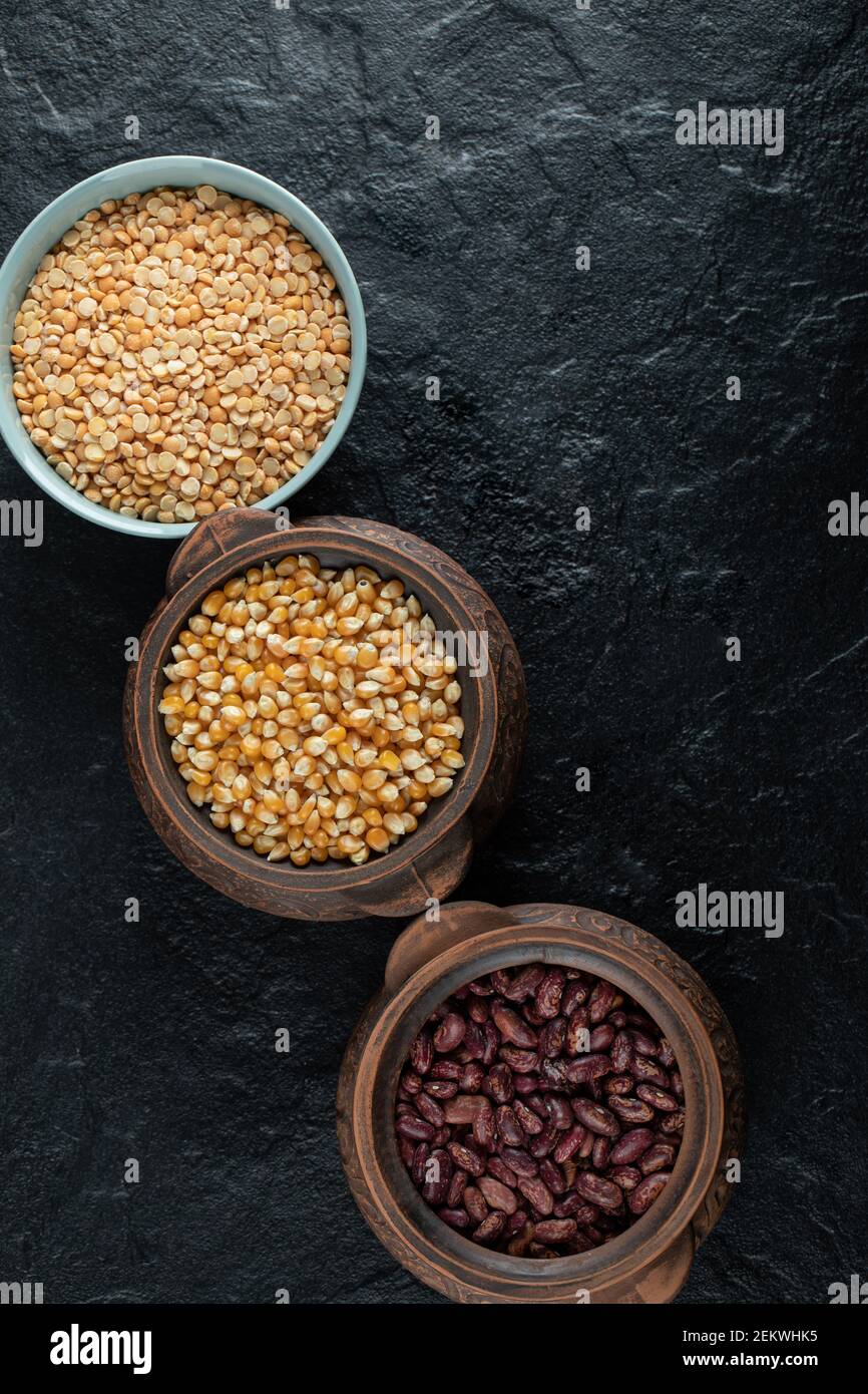 Different kinds of uncooked beans on ancient pots Stock Photo - Alamy