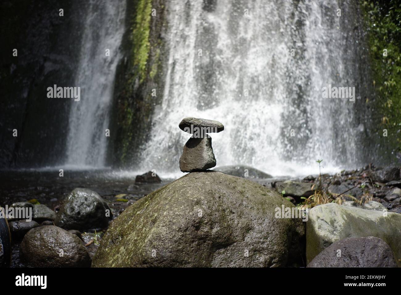 play rock balance in the river water flow. relaxation in the cool ...