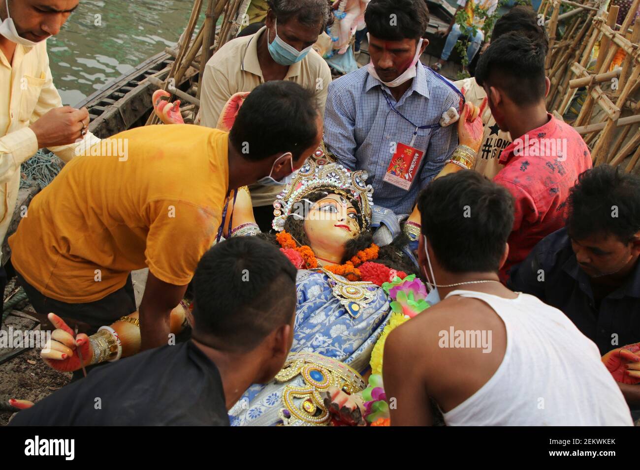 Hindu devotees submerge a clay idol of the Hindu goddess Durga in the ...