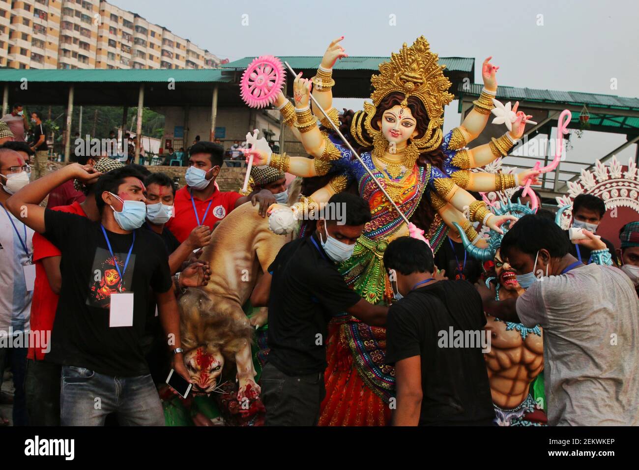 Hindu devotees submerge a clay idol of the Hindu goddess Durga in the ...