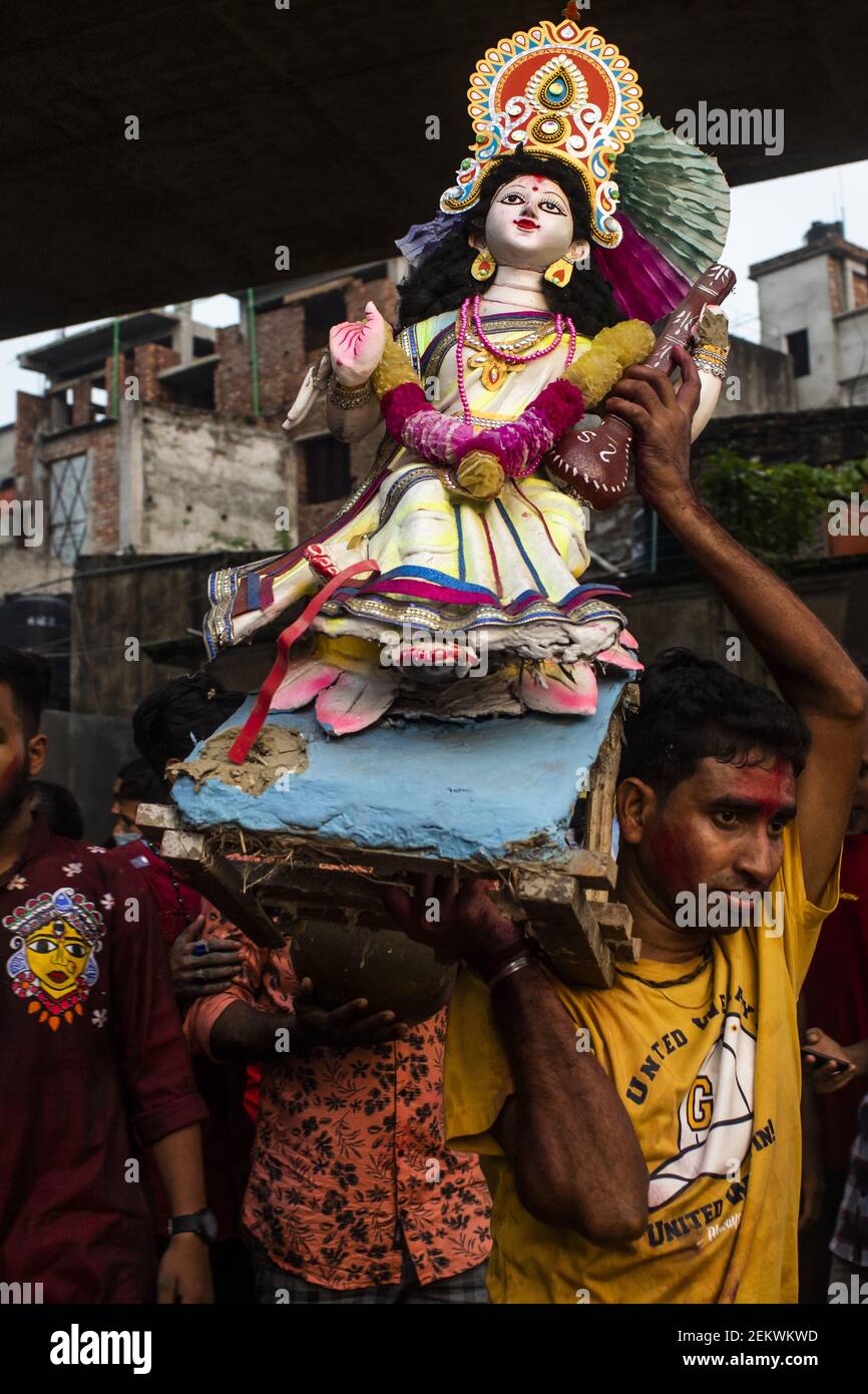 Hindu devotees carry an idol of the goddess Durga during the final day ...