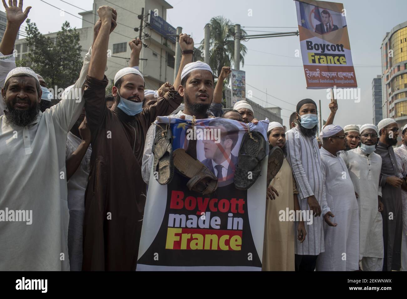 Muslim protesters display placards during the protest against French ...
