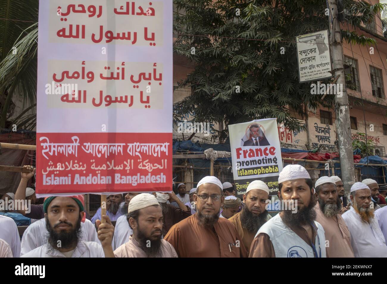Muslim protesters display placards during the protest against French ...