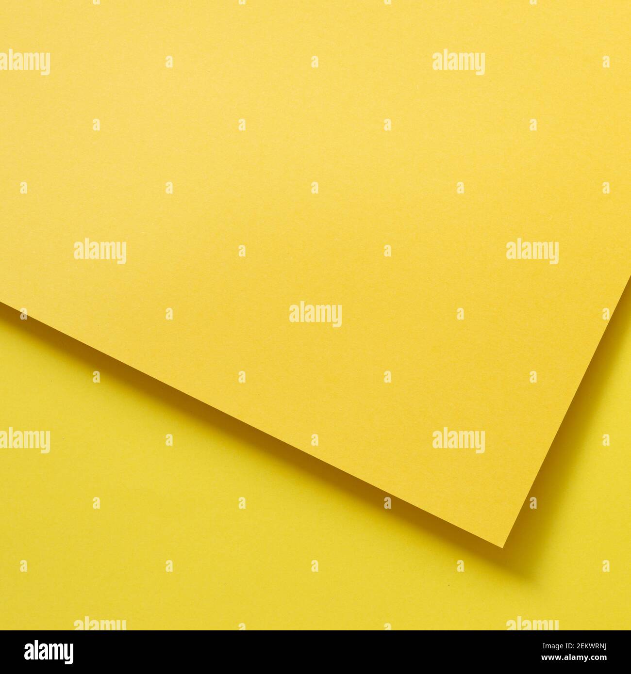 Yellow layered color paper background Stock Photo - Alamy