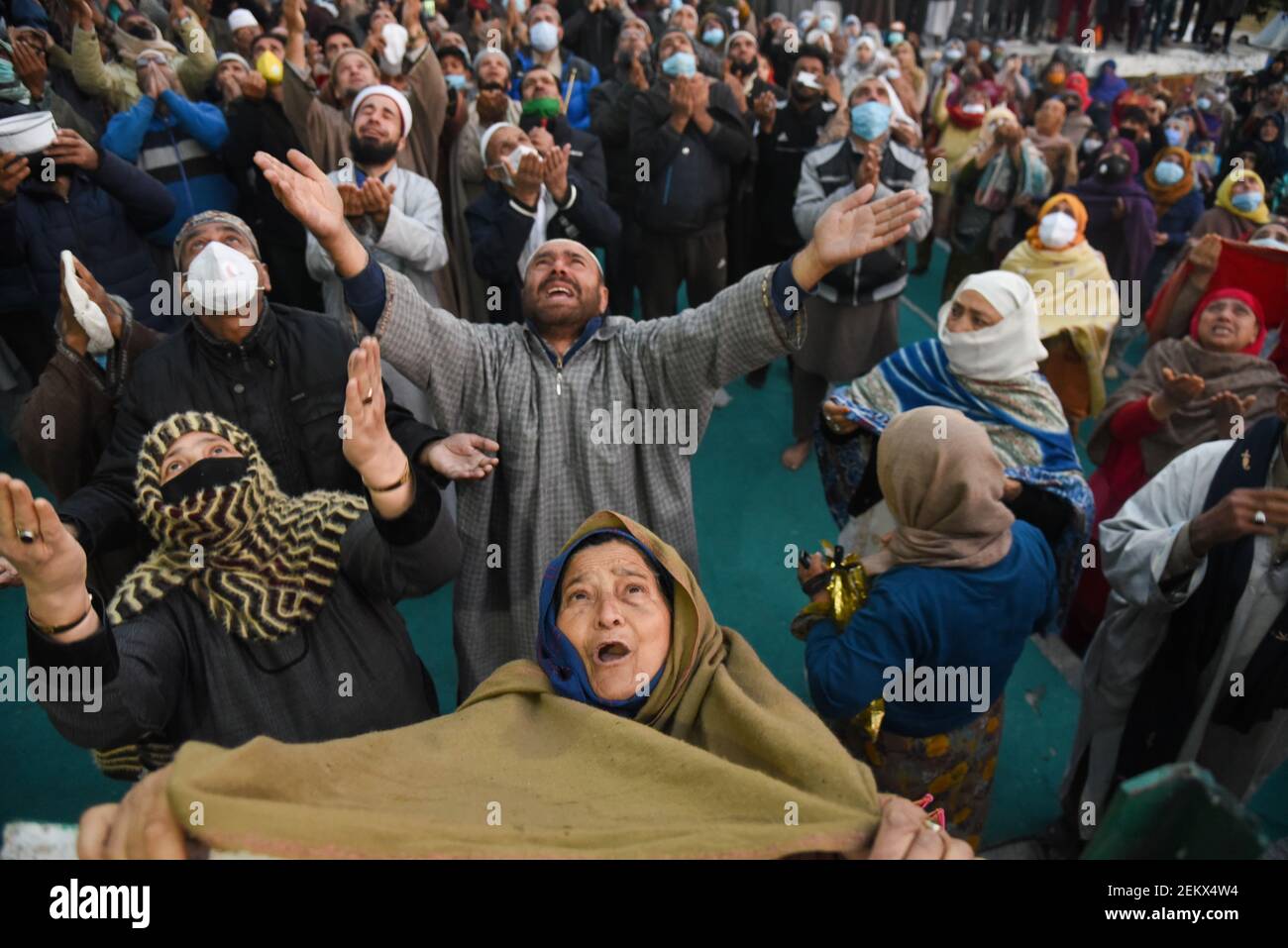 Kashmiri Muslim devotees raise their hands while beseeching for ...
