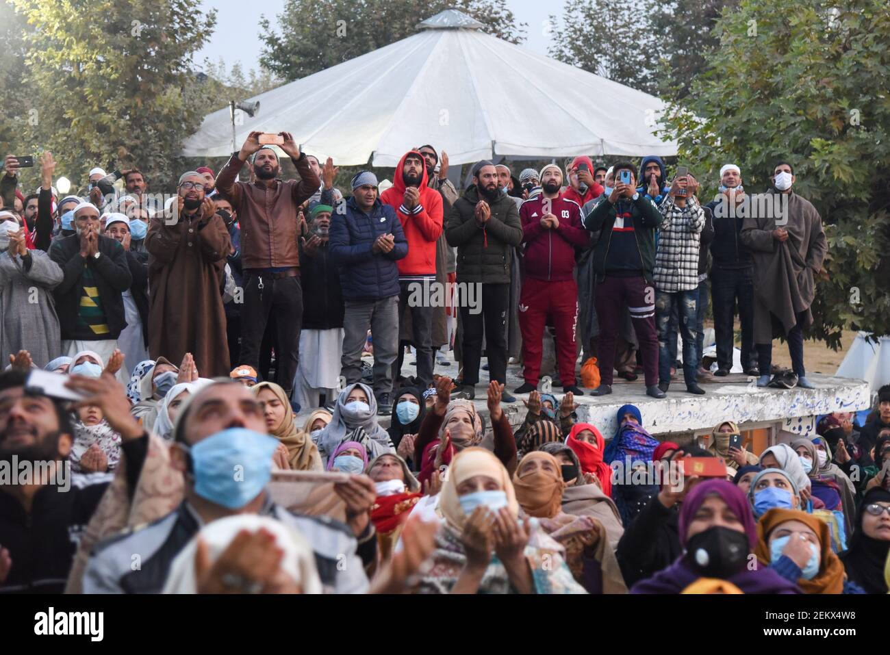 Kashmiri Muslim devotees raise their hands while beseeching for ...