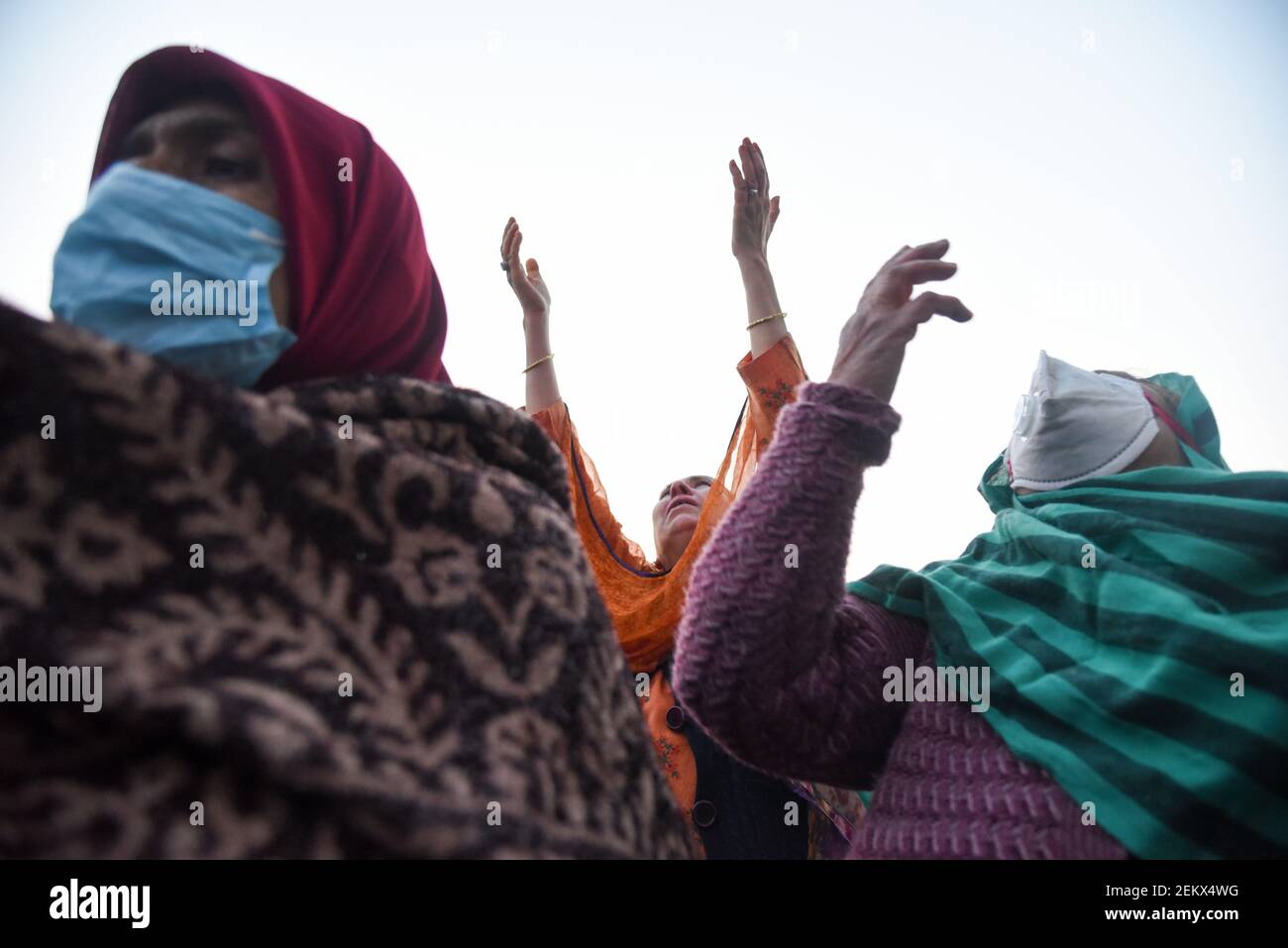 Kashmiri Muslim devotees raise their hands while beseeching for ...