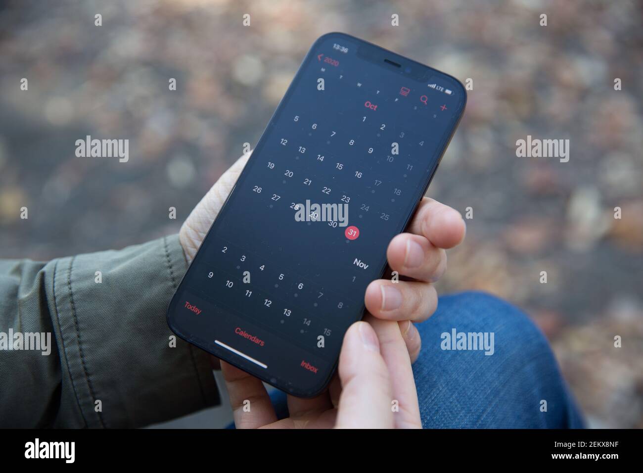 In this photo illustration a woman holds the new iPhone 12 in her hands ...
