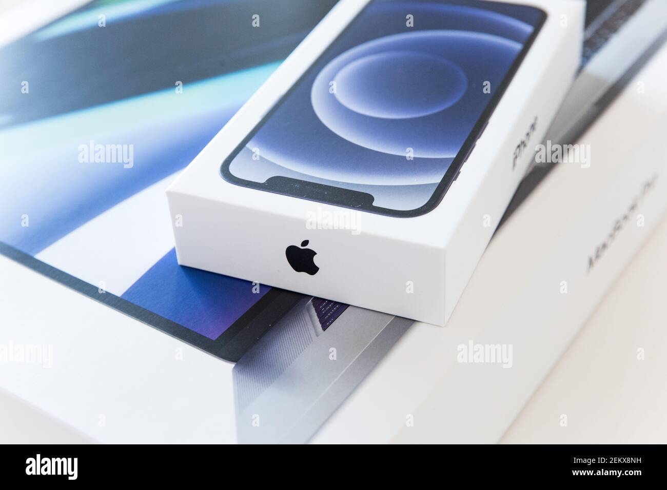In this photo illustration a new iPhone 12 package on top of a MacBook ...