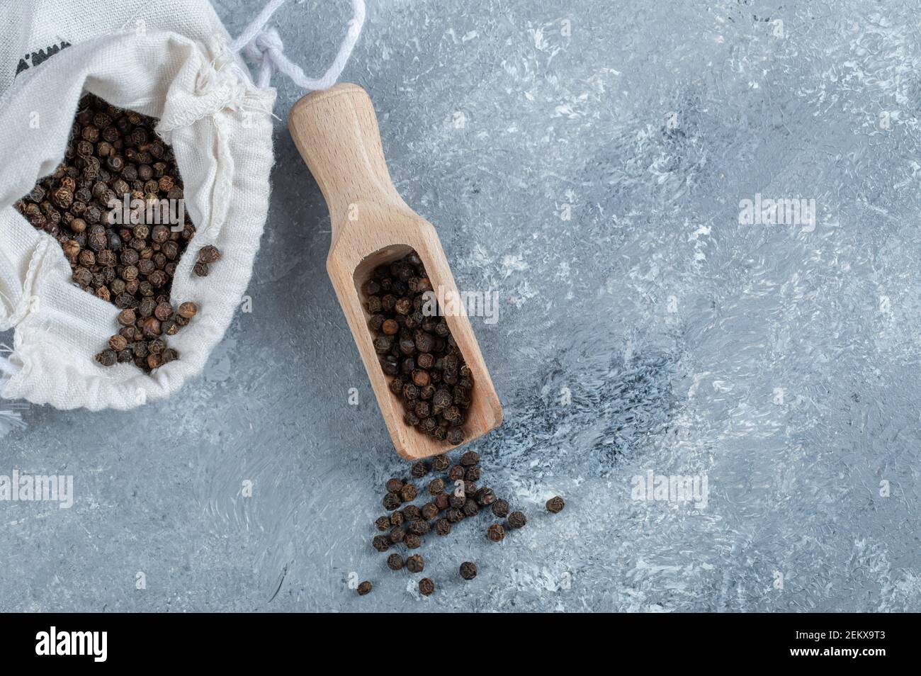 A white sack full of dried pepper on a gray background Stock Photo - Alamy