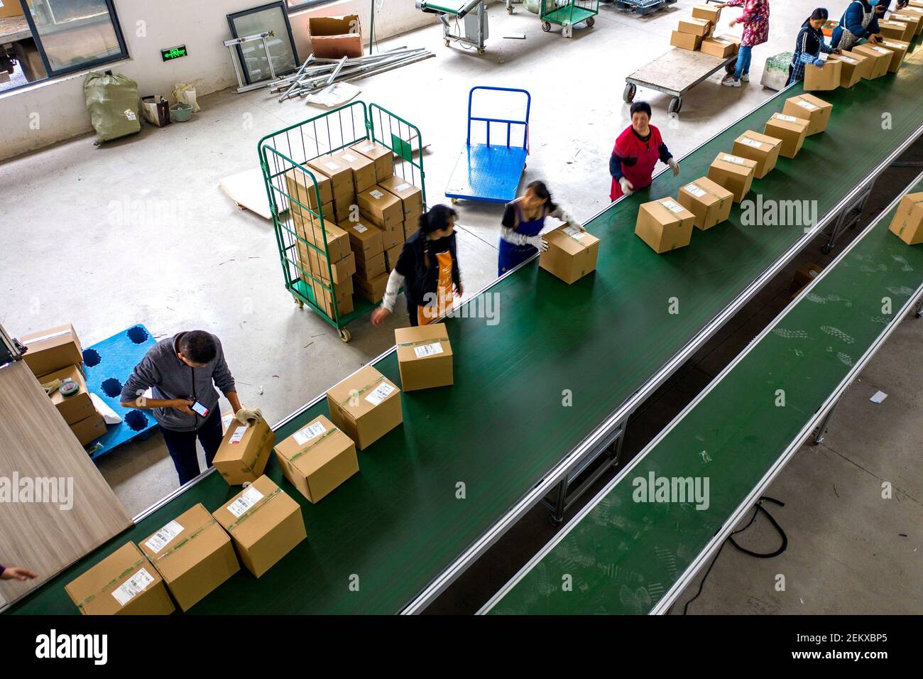 Staff pack and sort deliveries at a logistics center in Hefei city ...