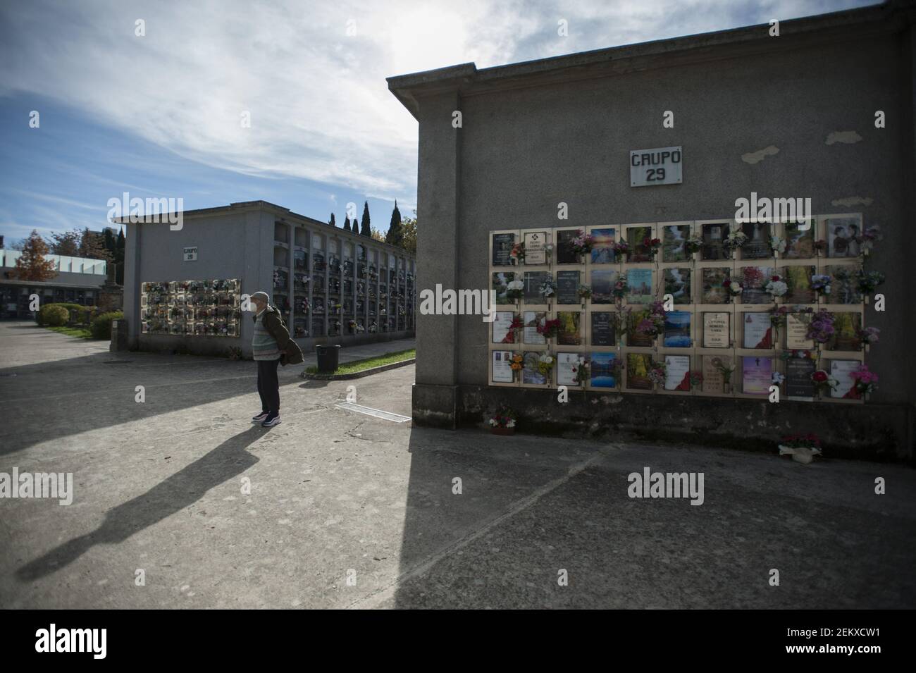 A man walking through the cemetery during the celebration of the feast ...