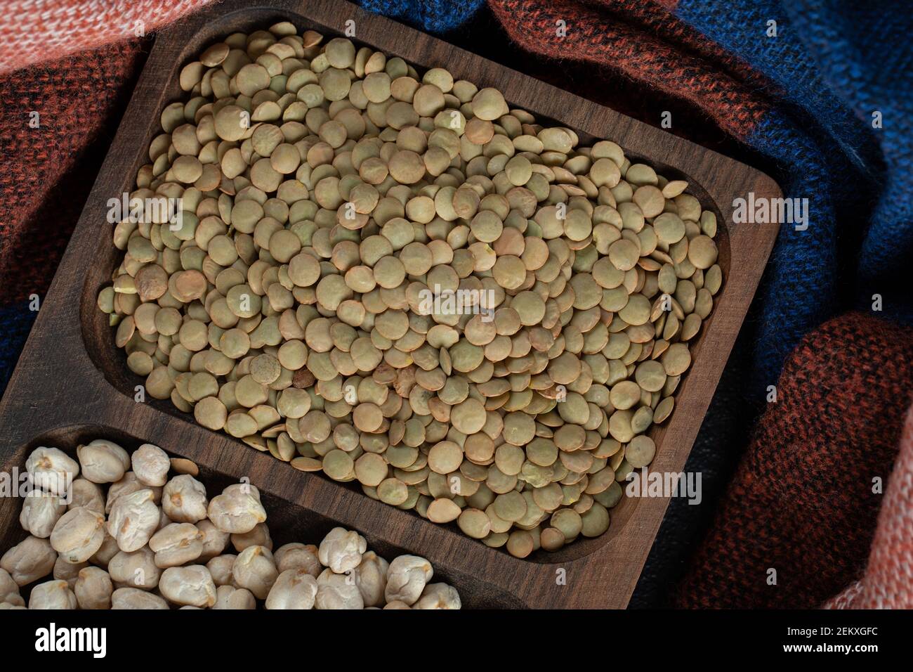 Wooden plates with raw peas and lentils on a dark background Stock ...