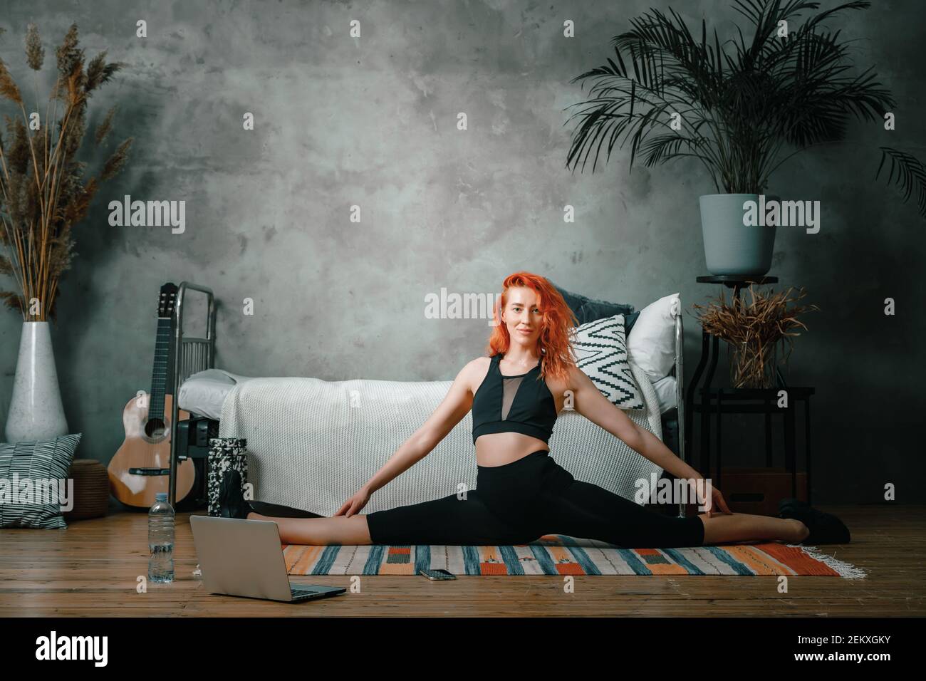 A young woman goes in for sports at home, online workout . The athlete ...
