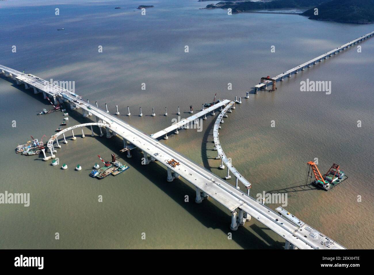 An aerial view of workers building the Zhoudai Bridge, which connect ...