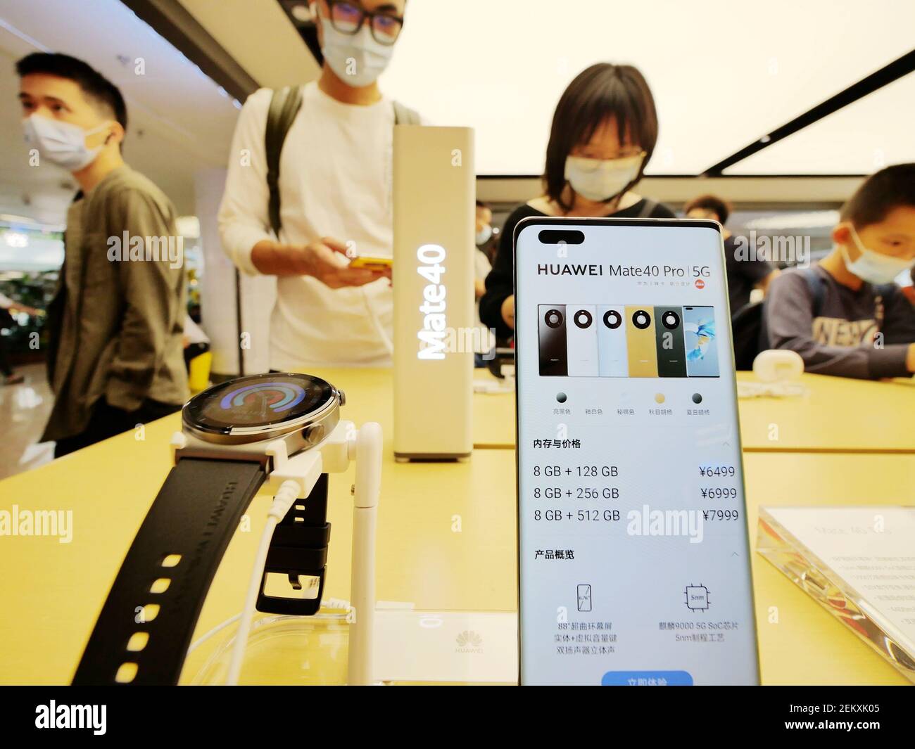 A Huawei Watch GT2 pro and Mate 40 smartphone are exhibited at a flagship store in Guangzhou ...