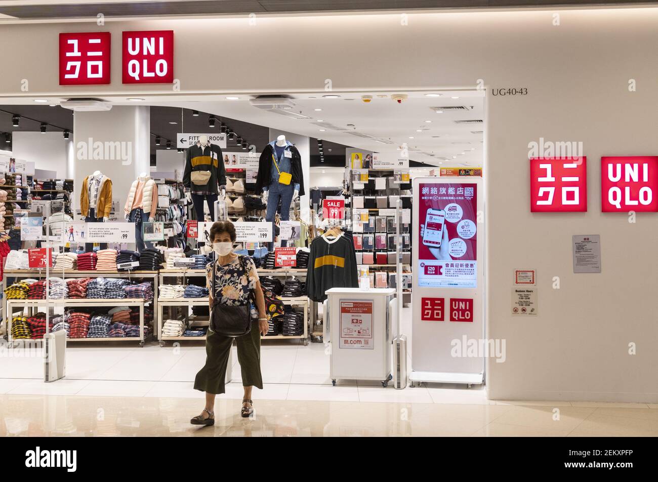 A customer wearing a face mask leaves the Japanese clothing brand ...